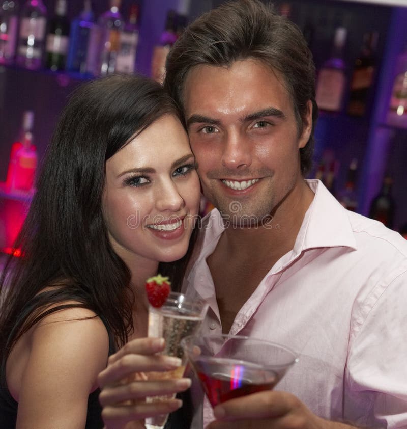 Young Couple Enjoying Drinks in Bar Stock Image - Image of together ...
