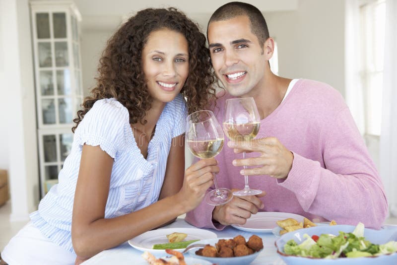 Young Couple Enjoying Meal Together Stock Image - Image of male ...