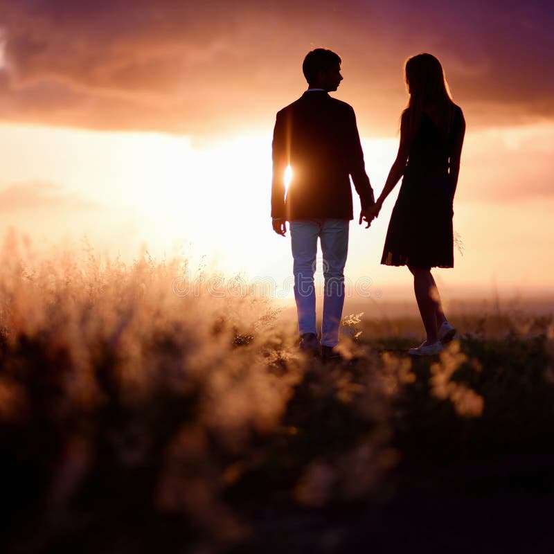 Young Couple Enjoying the Sunset Stock Photo - Image of back ...