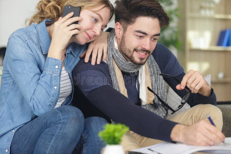 Young Couple Filling Out Form Stock Photo - Image of survey, domestic ...