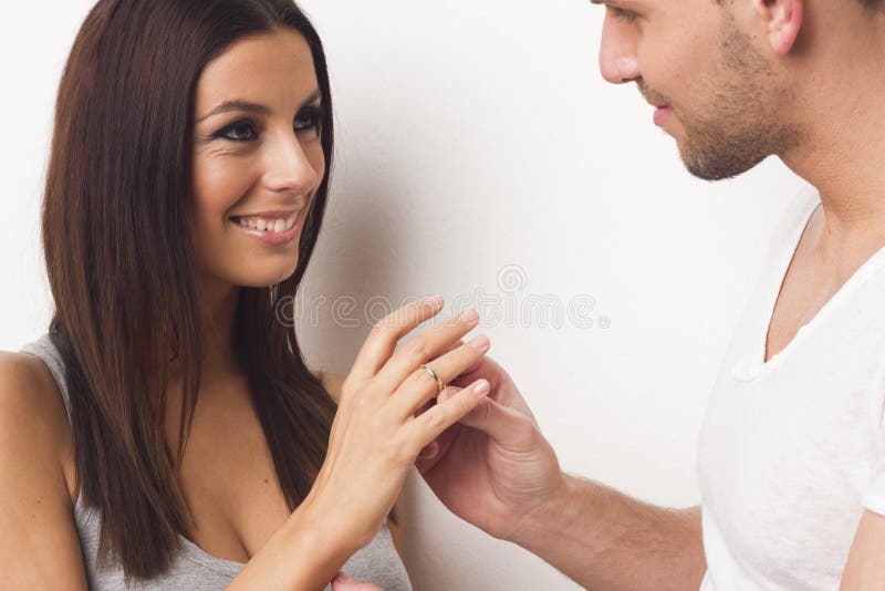 Young Couple Giving Each Other Engagement Ring Stock Photo - Image of ...