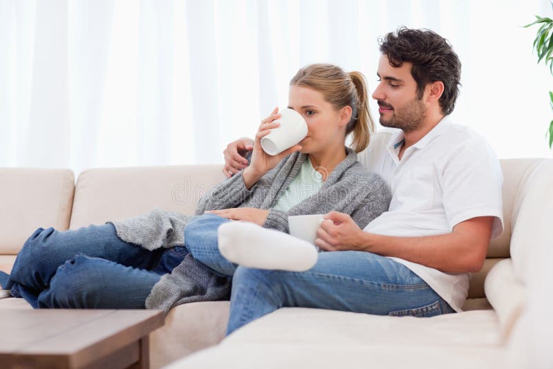 Young Couple Having a Cup of Tea Stock Image - Image of love, couch ...