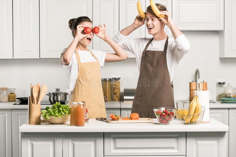 Young Couple Having Fun with Bananas and Tomatoes Stock Image - Image ...