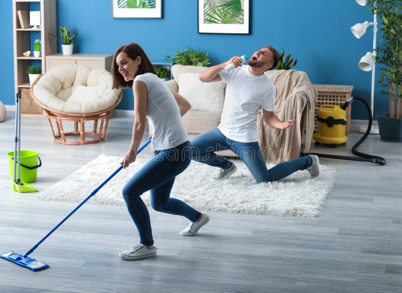 Young Couple Having Fun while Cleaning Their Flat Stock Image - Image ...