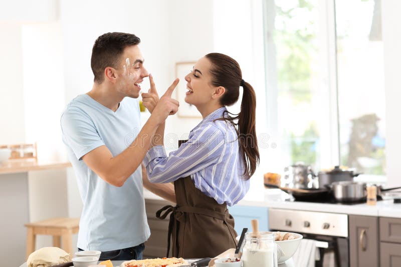 Young Couple Having Fun while Cooking in Kitchen Stock Photo - Image of ...