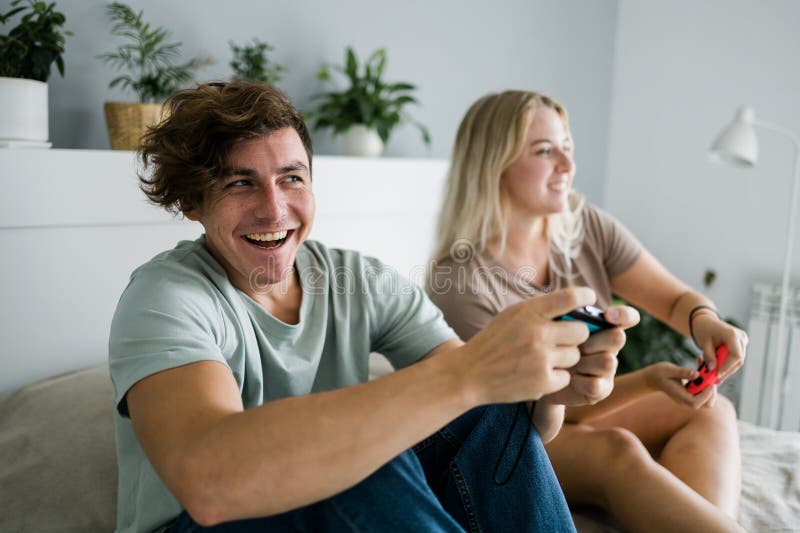 Young Couple Having Fun at Home Playing Video Games. Technologies and Gaming Concept Stock Photo ...