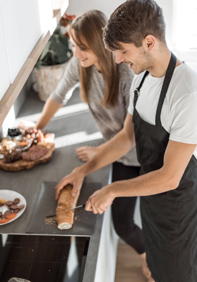 Young Couple Having Fun Making Sandwiches for Breakfast. Stock Photo ...