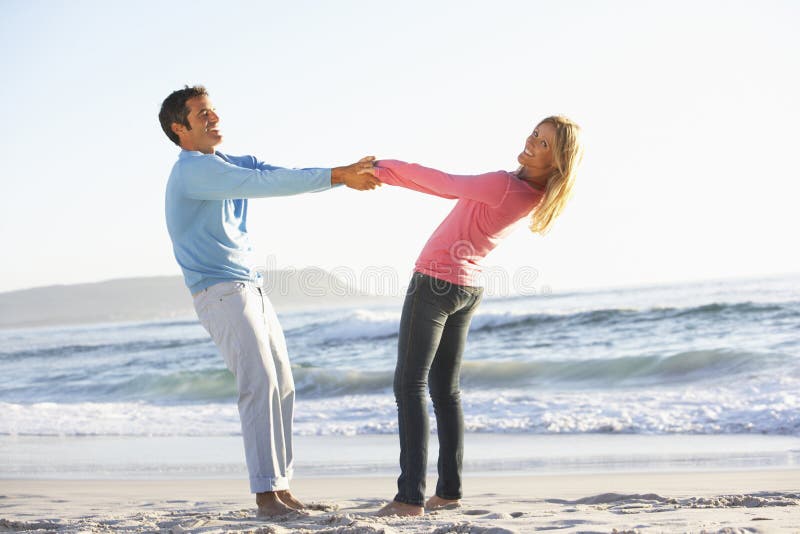 Young Couple Having Fun on Sandy Beach Stock Image - Image of person ...