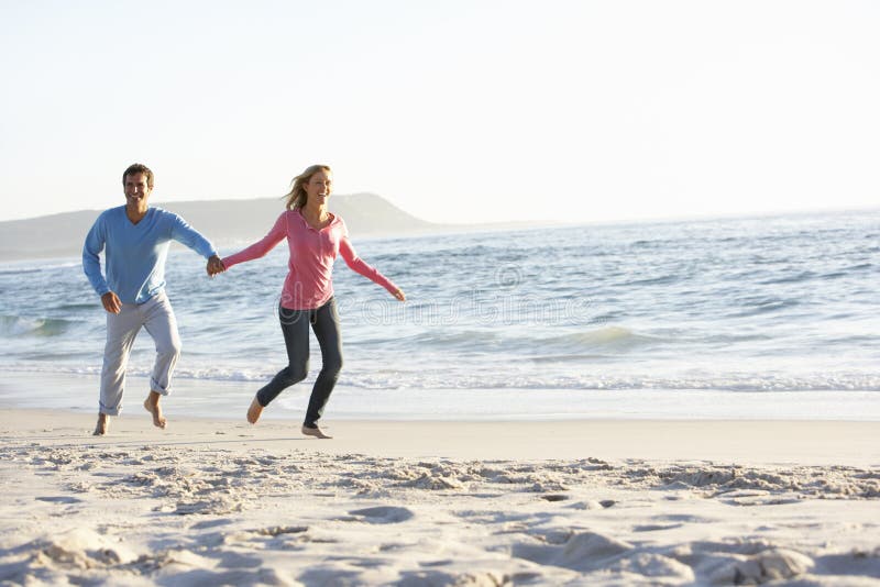 Young Couple Having Fun on Sandy Beach Stock Photo - Image of smiling ...