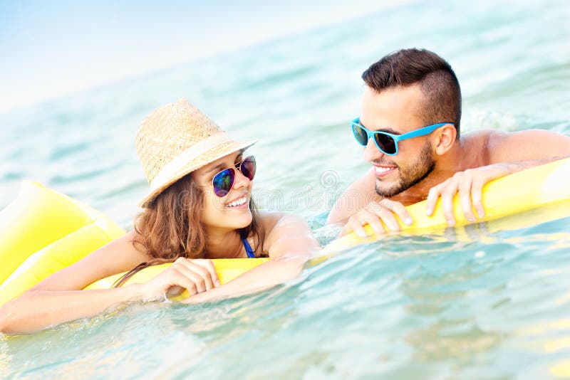 Young Couple Having Fun in the Sea Stock Photo - Image of laughing ...