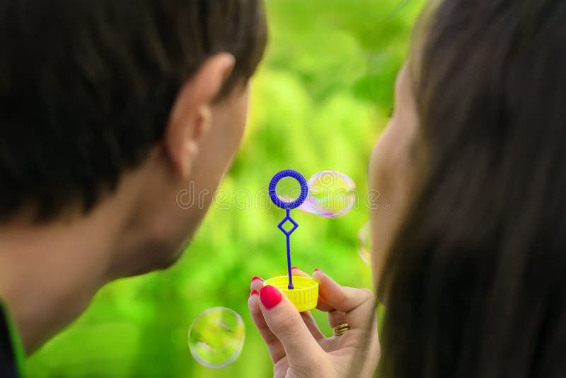 Young Couple Having Fun with Soap Bubbles in the Park Stock Image ...