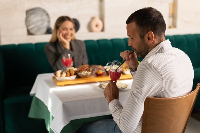 Young Couple Having Lunch and Drinking Fresh Squeezed Juice in the ...
