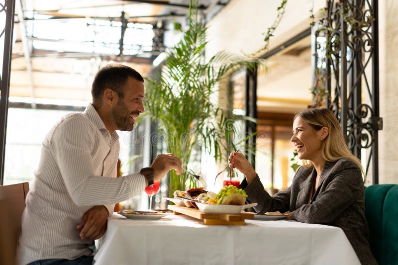 Young Couple Having Lunch and Drinking Fresh Squeezed Juice in the ...