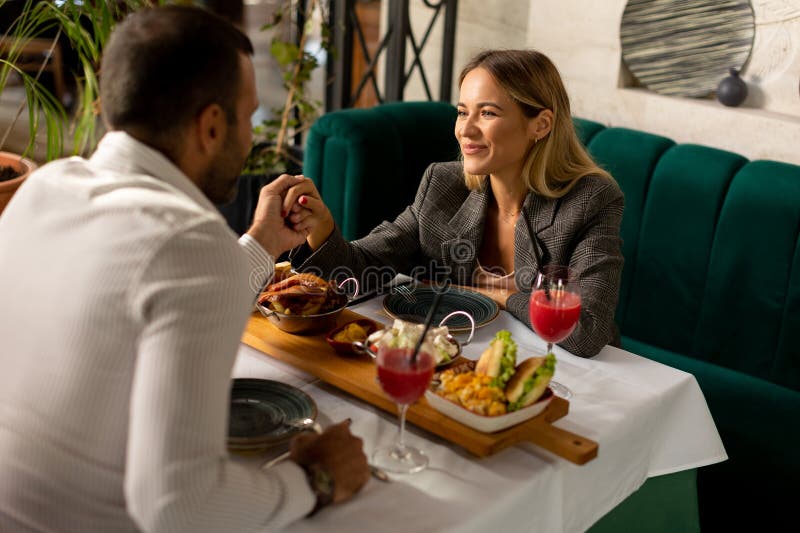 Young Couple Having Lunch and Drinking Fresh Squeezed Juice in the ...