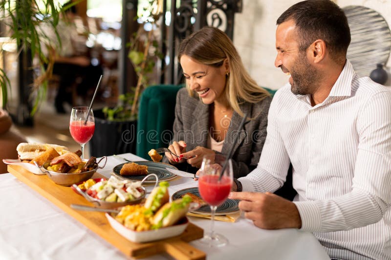 Young Couple Having Lunch and Drinking Fresh Squeezed Juice in the ...