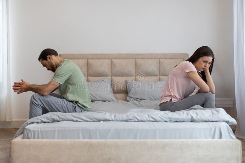 Young Couple Having Relationship Difficulties Sitting On Opposite