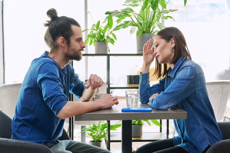 Young Couple Having Serious Conversation while Sitting Together in Cafe ...
