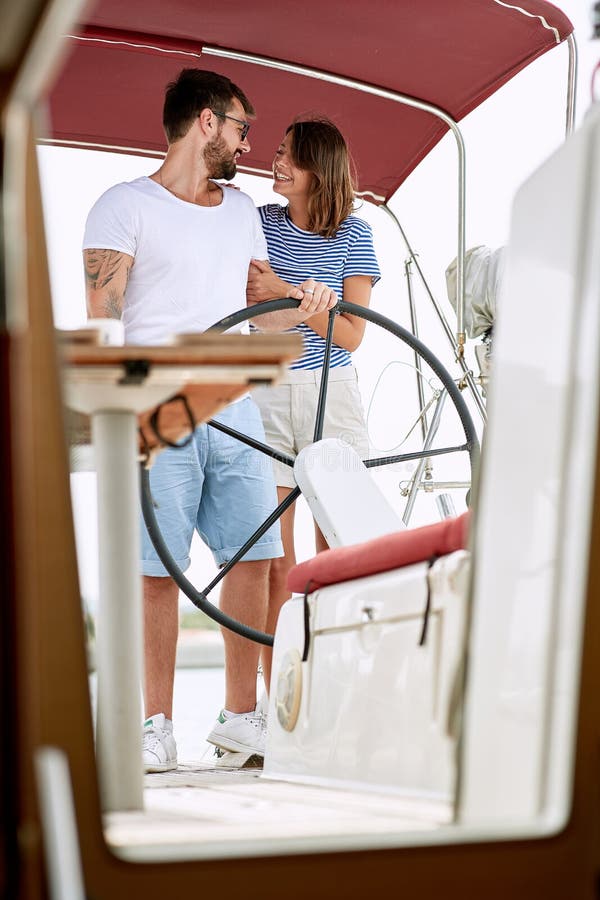 Young couple at the helm stock photo. Image of outdoor - 191662438