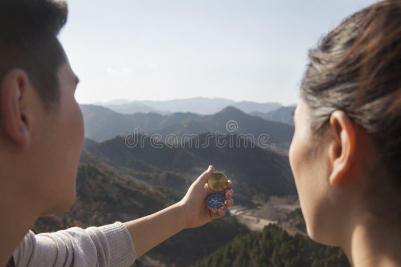 Young Couple Hiking and Looking at the Compass Stock Image - Image of ...