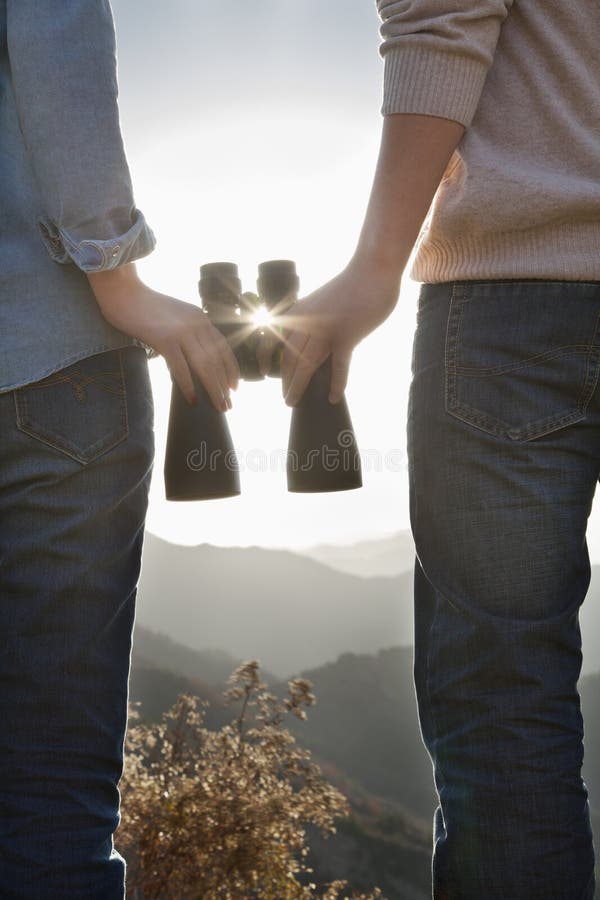 Young Couple Holding Binoculars and Looking at the Sun Stock Photo ...
