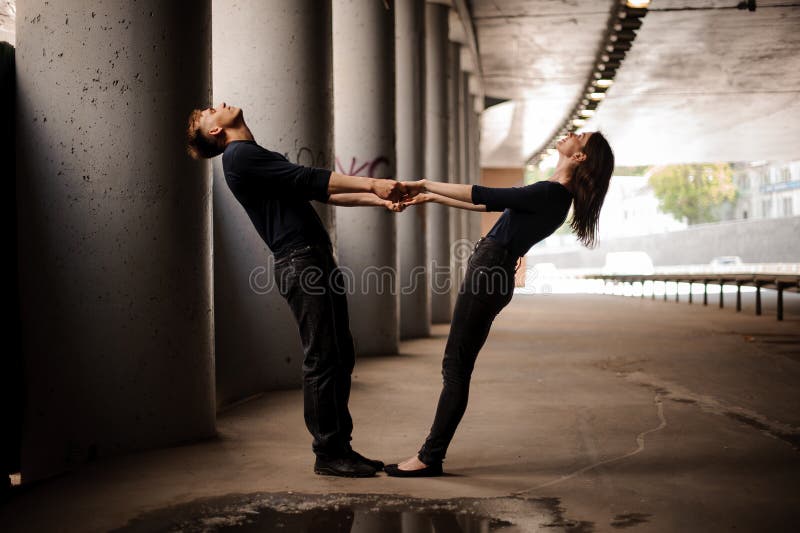 Young Couple Holding Hands and Leaning Back, Trusting Each Other Stock ...
