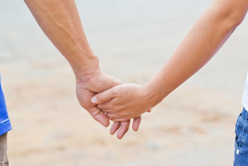 Young Couple Holding Hands - View from Back Stock Image - Image of ...