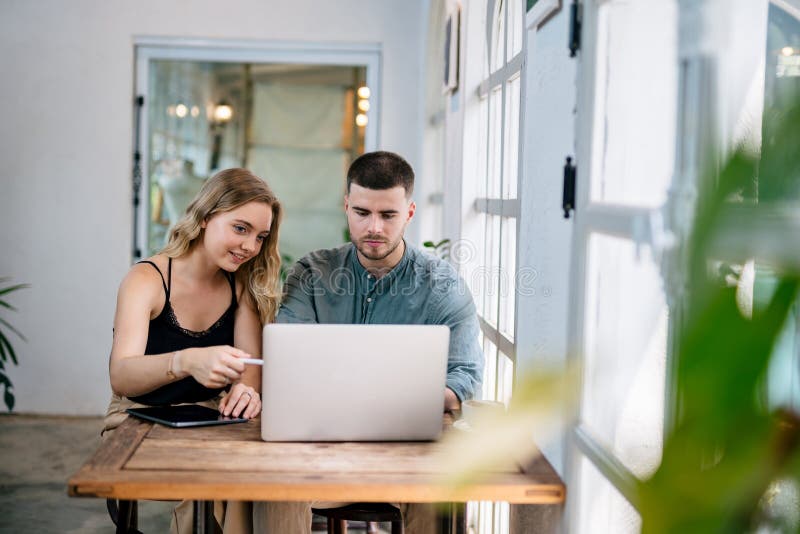 Young Couple at Home in Lounge Using Laptop Computer. the Concept of ...