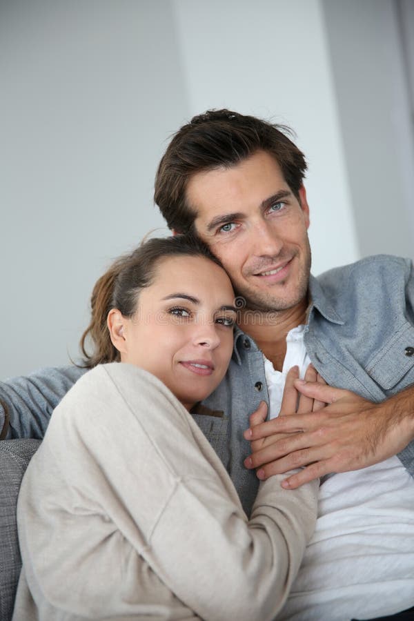 Young Couple at Home Relaxing Stock Image - Image of embracing ...