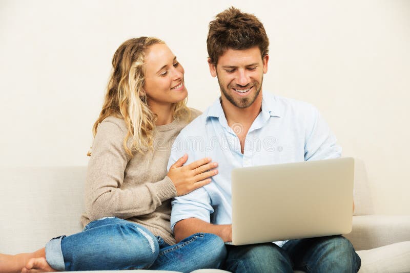Young Couple at Home Using Laptop Stock Photo - Image of couple ...