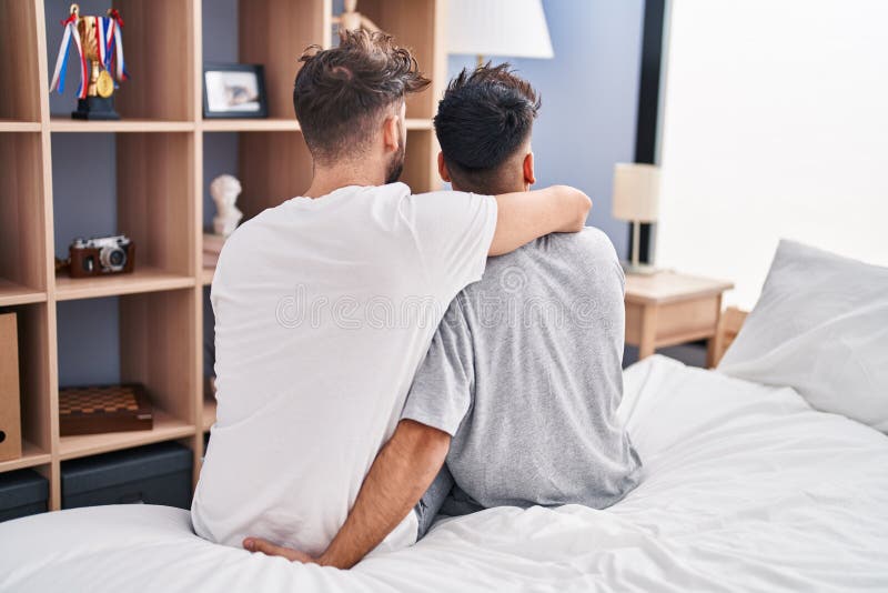 Young Couple Hugging Each Other Sitting on Bed at Bedrooom Stock Photo ...