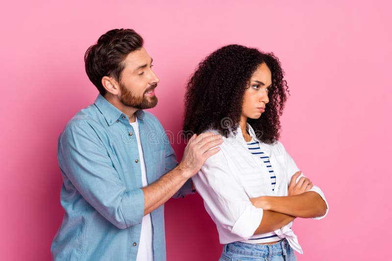 Young Couple Interacting on a Pink Background Emphasizing Emotions and ...