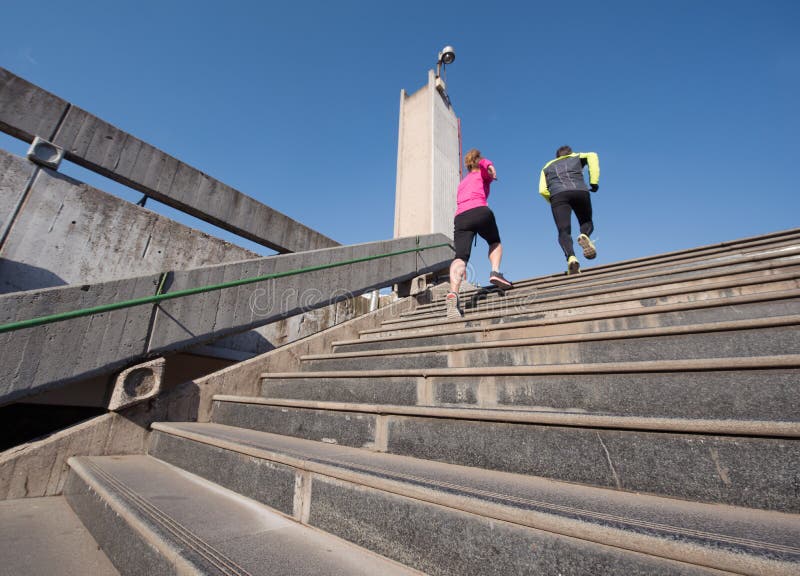 Young Couple Jogging on Steps Stock Image - Image of flare, friends ...