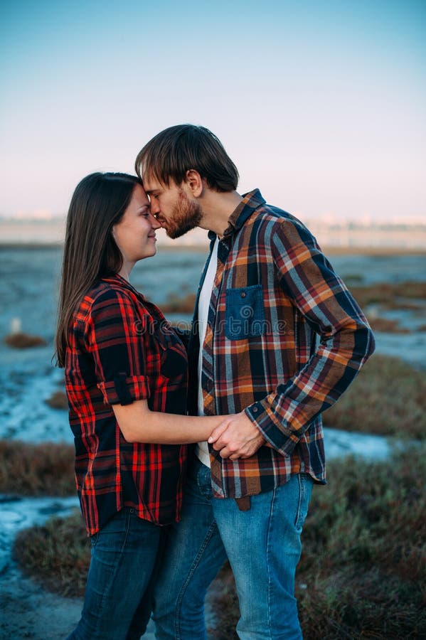 Young Couple Kissing and Hugging Stock Photo - Image of sunlight ...