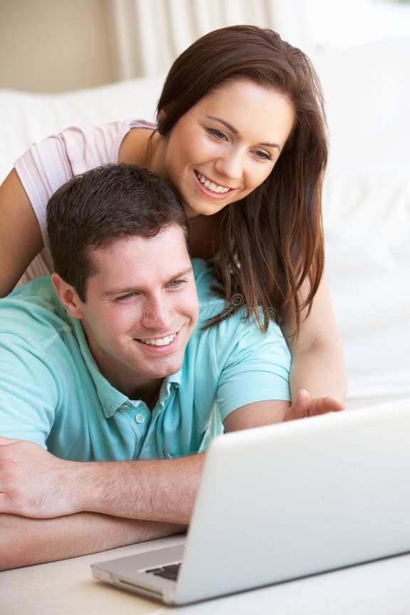 Young Couple on Laptop Computer Stock Photo - Image of interior, couple ...