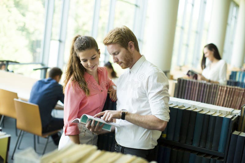 Young Couple in the Library Stock Image - Image of indoor, female: 60334189