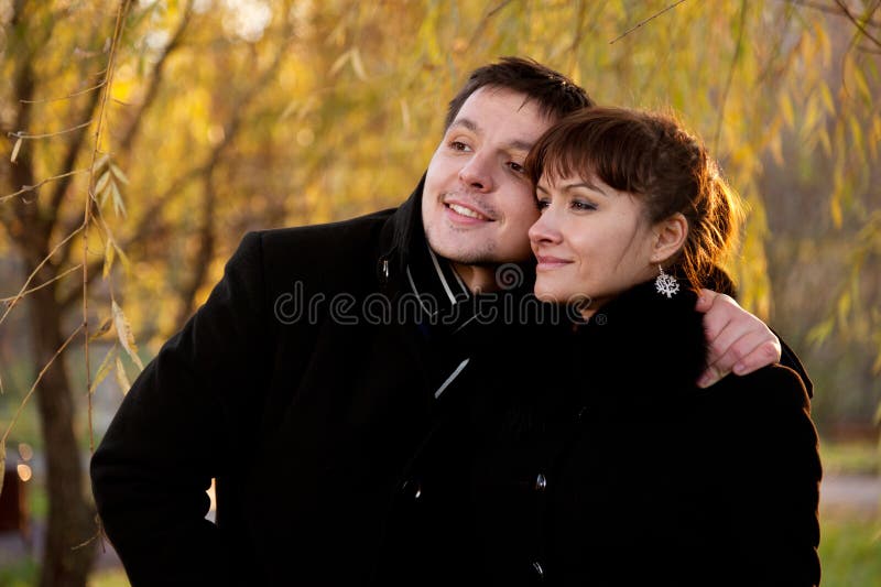Young Couple Looking Forward at Autumn Background Stock Image - Image ...