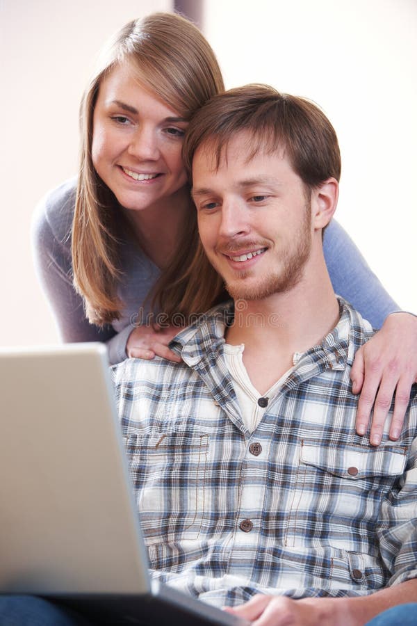 Young Couple Looking at Laptop Together Stock Photo - Image of laptop ...