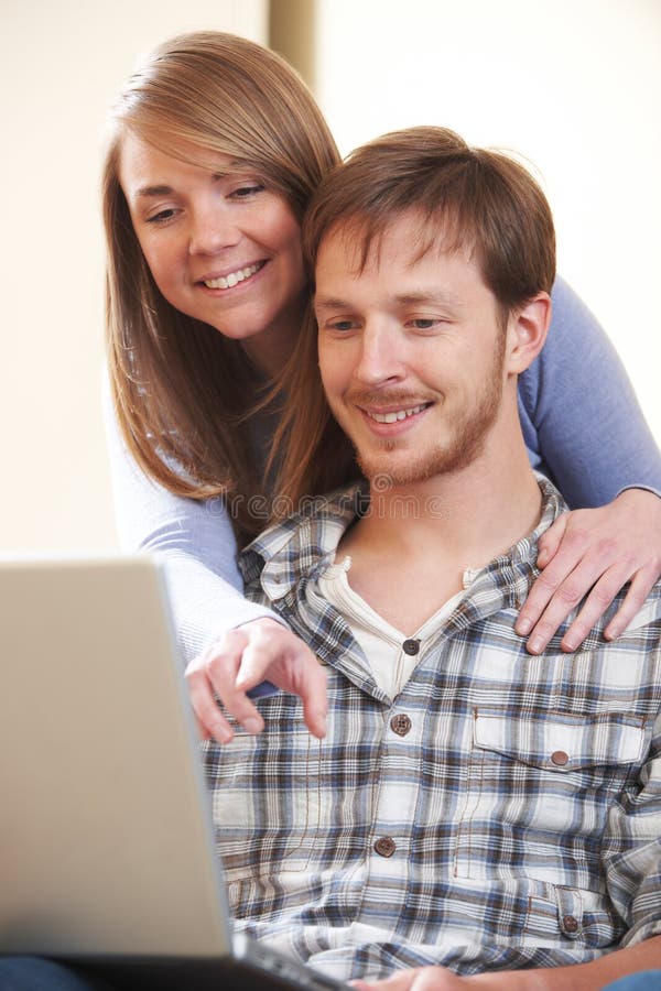 Young Couple Looking at Laptop Together Stock Image - Image of laptop ...
