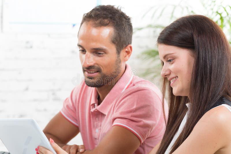 A Young Couple Looking at a Tablet Stock Image - Image of wife ...
