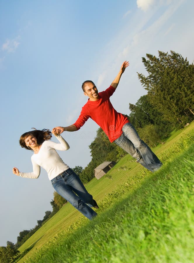 Couple Chasing One Another through Dunes Stock Photo - Image of ...