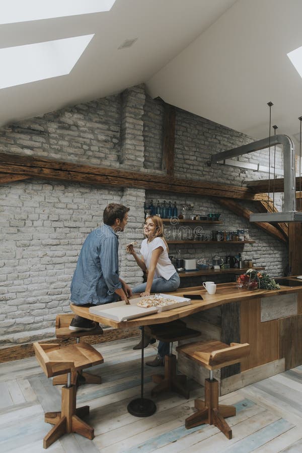 Young Couple in Love Eating Pizza in the Rustic Home Stock Image ...