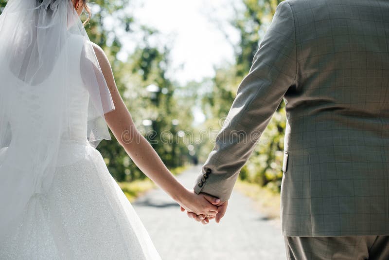 Young Couple in Love Holding Hands and Looking into the Distance Stock ...