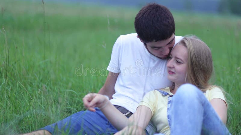 Young Couple in Love Lying on the Grass in the Field, Hugging and ...