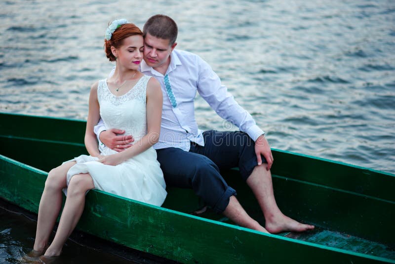 Young Couple in Love Sitting in a Small Boat and Having Fun Stock Photo ...