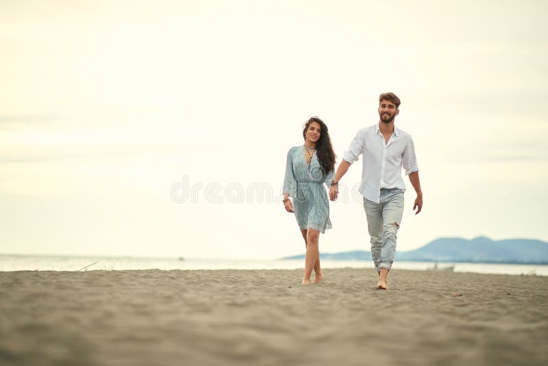 Young Couple in Love Strolling the Beach Stock Image - Image of ...