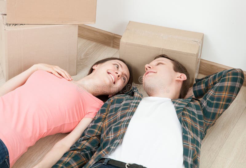 Young Couple Lying on the Floor among Cardboard Boxes Stock Image ...