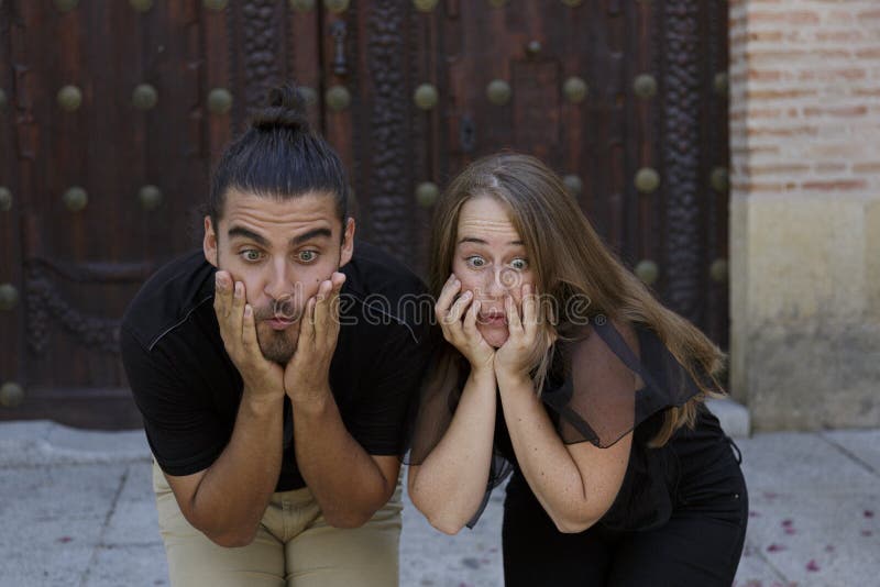 A Young Couple Making Expressions with Their Faces and Hands Stock ...