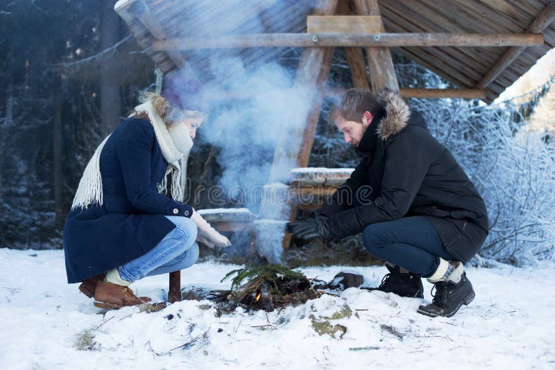Young couple making fire stock photo. Image of making - 40348386