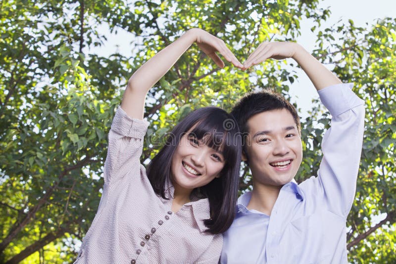 Young Couple Making a Heart Shape with Their Arms Stock Photo - Image ...