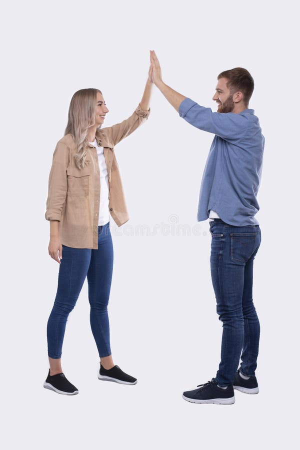 Young Couple Making High Five Standing Isolated. Sign Stock Photo ...